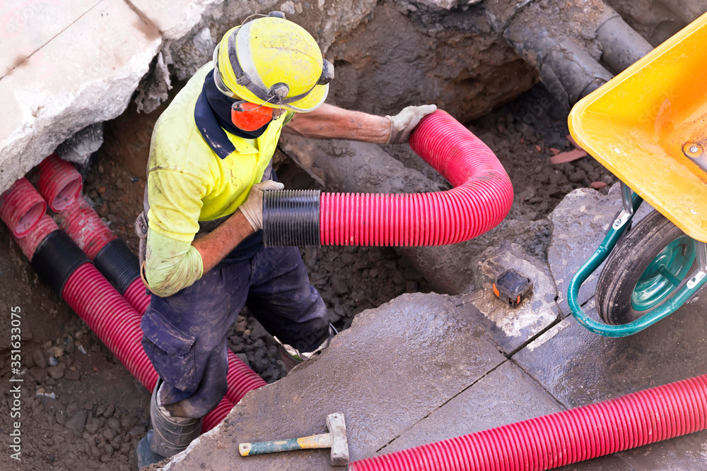 construction worker for restoir and repair pipes for underground ...