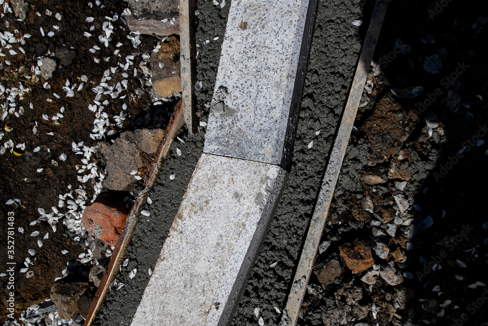 Setting road border before laying asphalt. Reconstruction of the ...