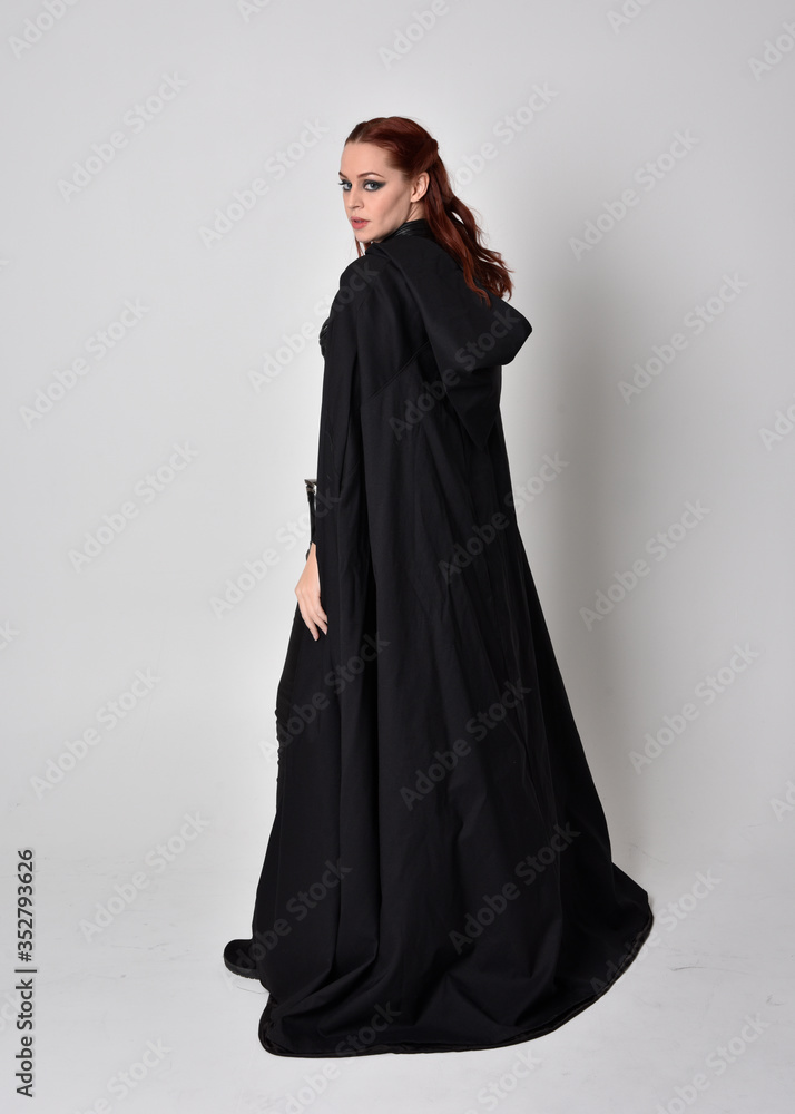 fantasy portrait of a woman wearing long black cloak. Full length ...