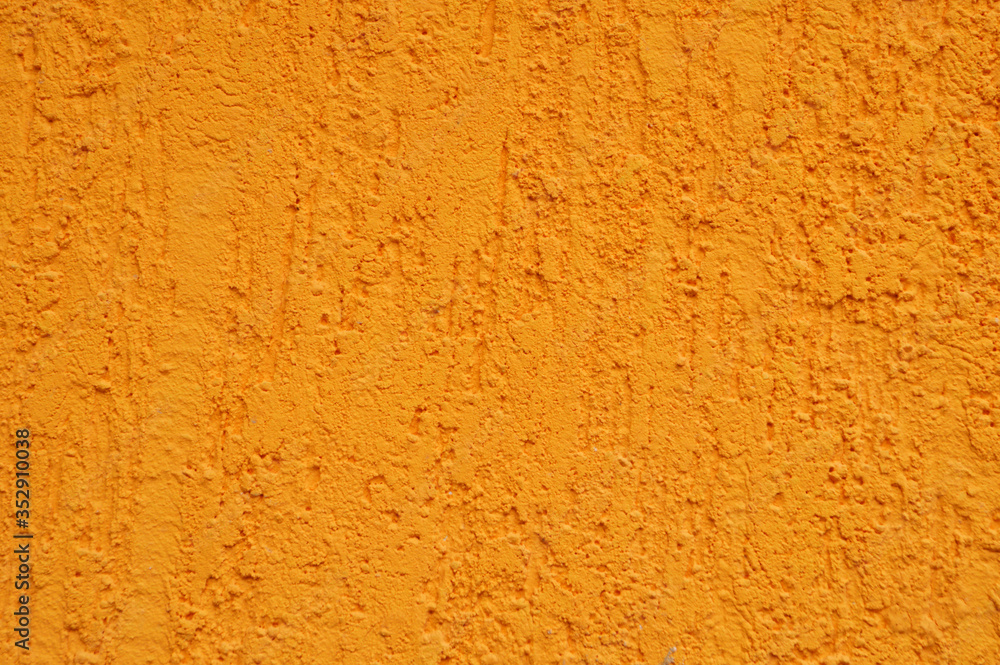 Acrylic coating. Facade relief stucco and bright orange paint. Texture ...