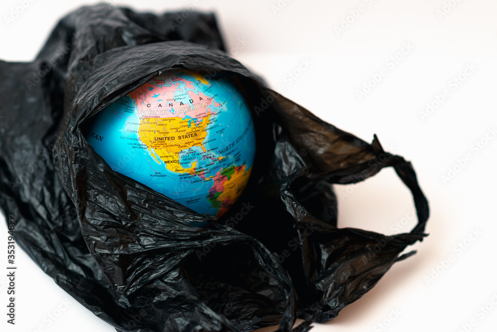 World Globe inside plastic bag you can see in hole different parts of ...