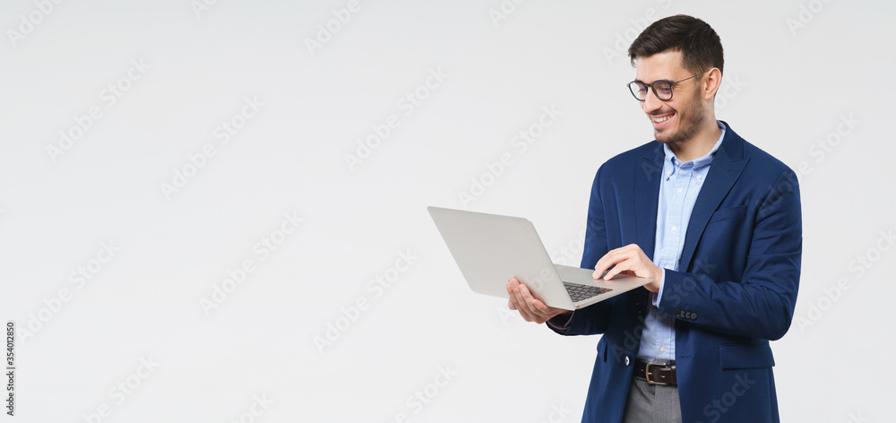 Horizontal banner of young handsome smiling business man holding laptop ...