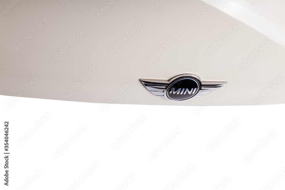A stylish nameplate of a car brand of the Mini Cooper model on the hood ...