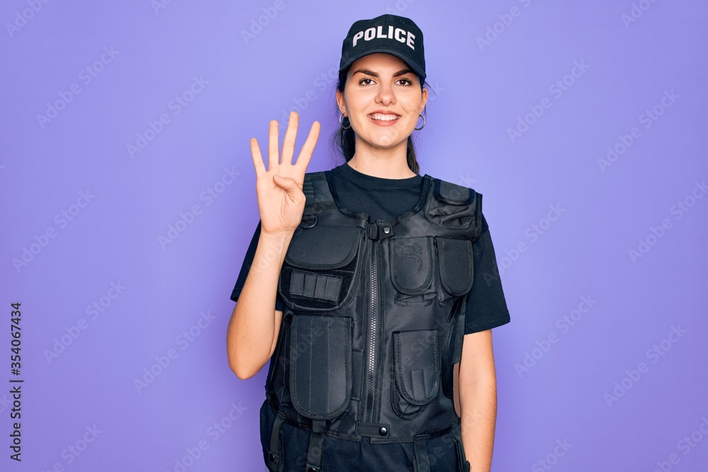 Young police woman wearing security bulletproof vest uniform over ...