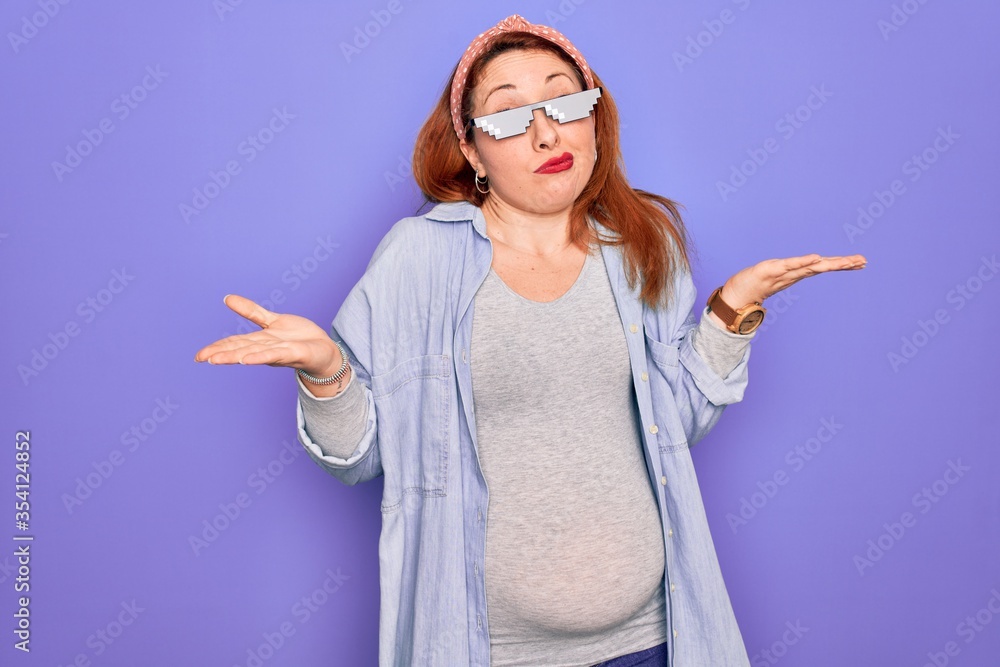 Young redhead pregnant woman expecting baby wearing funny thug life ...