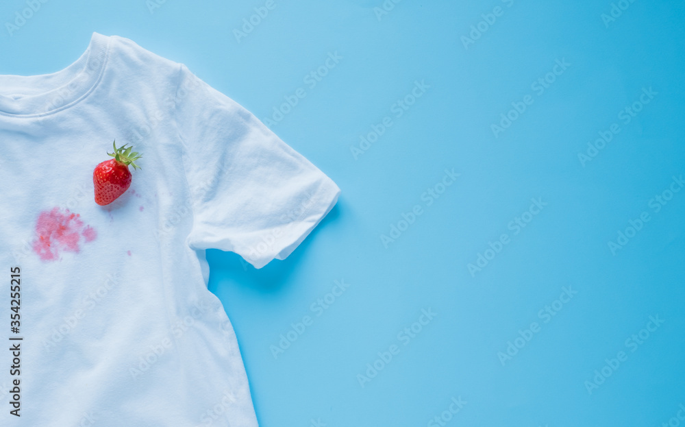 Dirty strawberry stain on fabric from accidents in everyday life. The ...