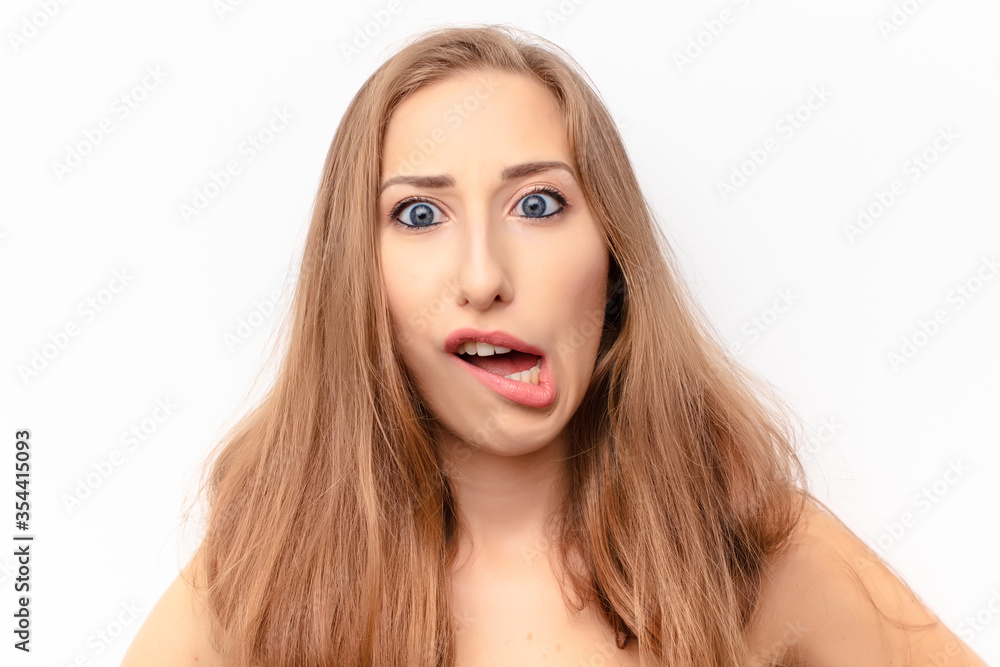 young pretty woman with a goofy, crazy, surprised expression, puffing ...