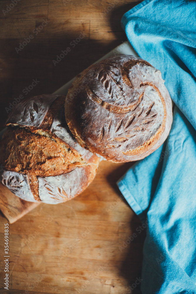 Vertical photo of homemade sourdough bread with score design, Freshly ...