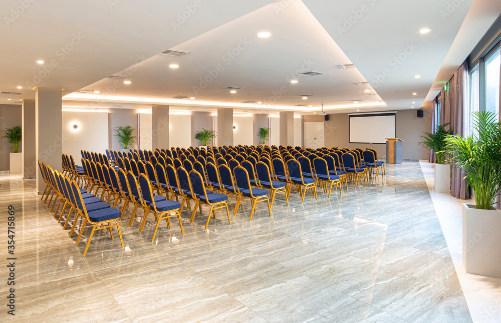Side view of luxury auditorium interior with empty white screen and ...