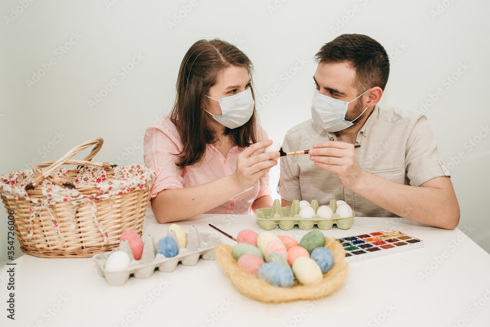 Young white European couple celebrating paint Easter quarantine at home ...