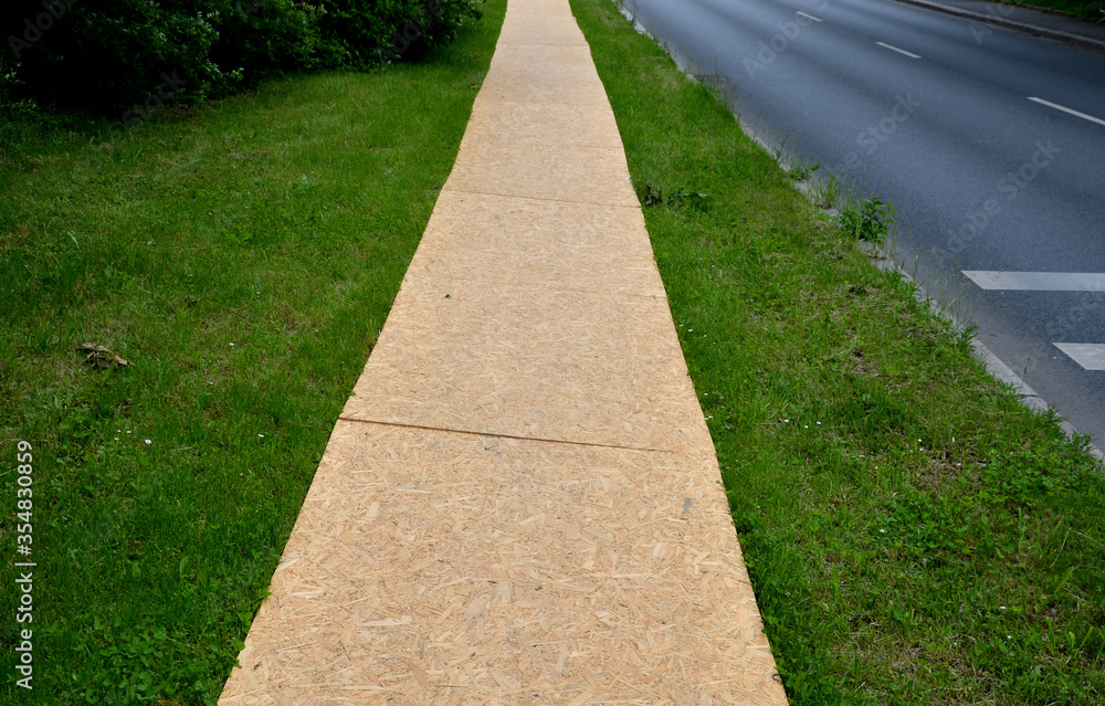 temporary sidewalk temporarily built of wooden osb boards as a safe ...