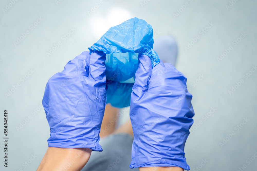 Woman wearing foot protection for Covid19 hygienic protection against ...