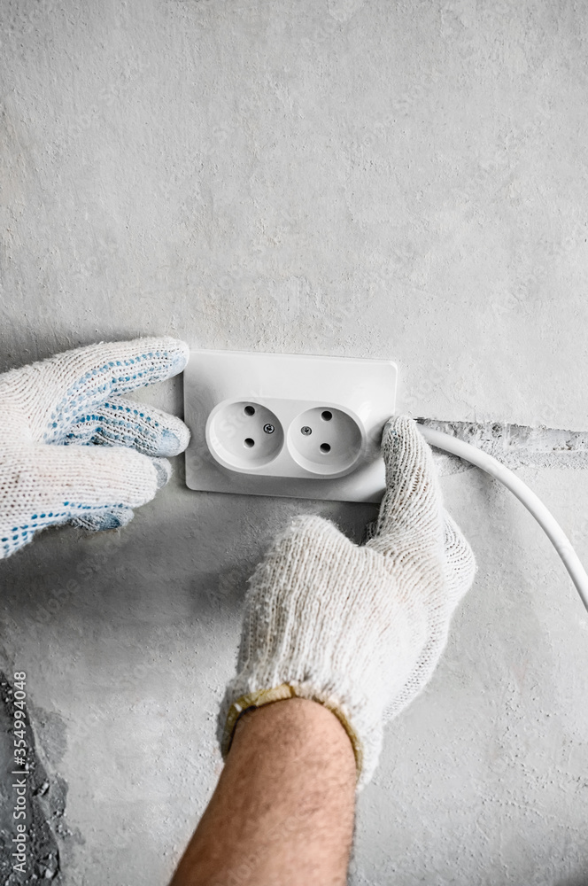 Work on the installation of electrical outlets. The wizard replaces the ...