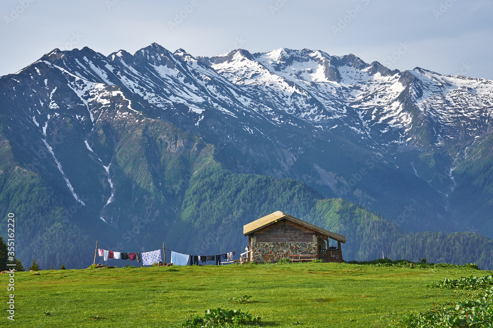 Traditional house of Sal Plateau with the background of snowy mountains ...