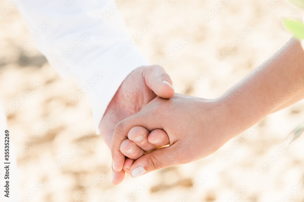 Newlyweds at the wedding romantic couple holding hands during ...