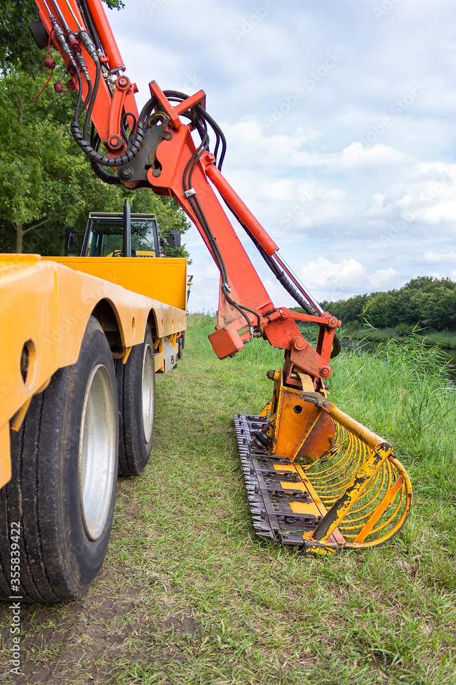 Hydraulic grab with cutter bar in verge of channel Stock Photo | Adobe ...