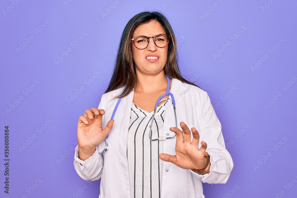 Professional doctor woman wearing stethoscope and medical coat over ...