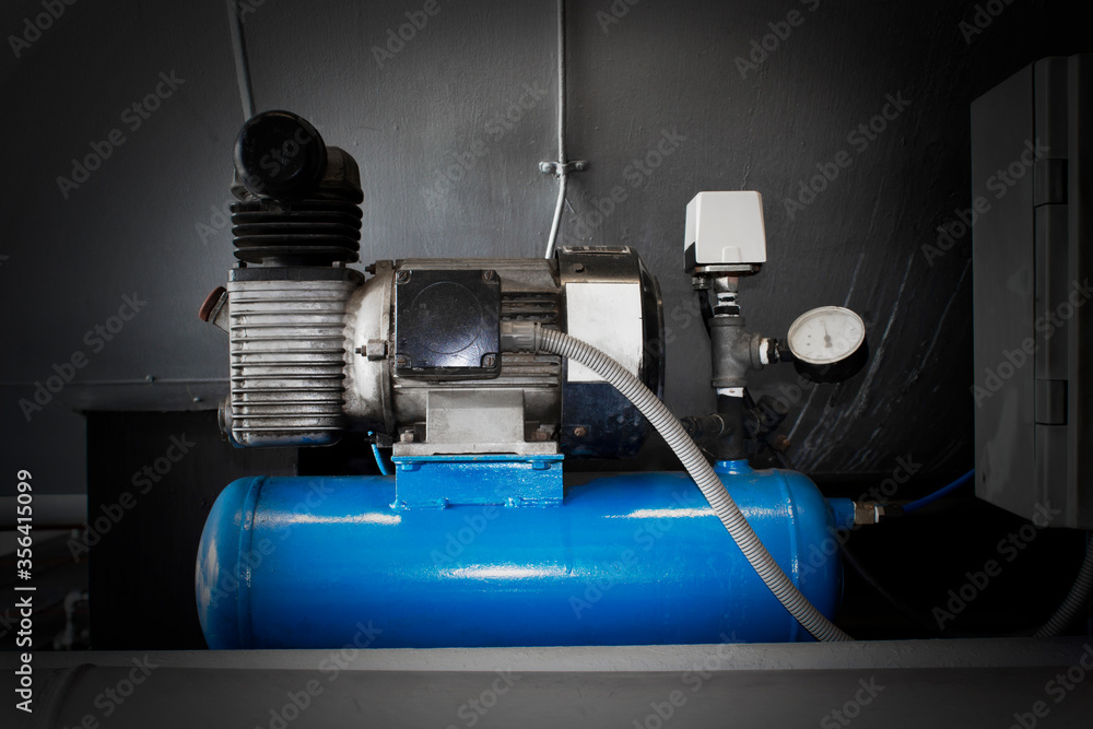 Air compressor machine used in the factory. Stock Photo | Adobe Stock