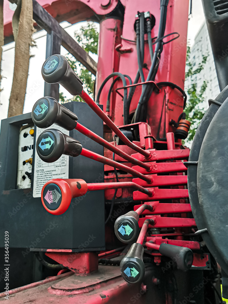 Image of hydraulic control valve on the side of the mobile crane. Red ...
