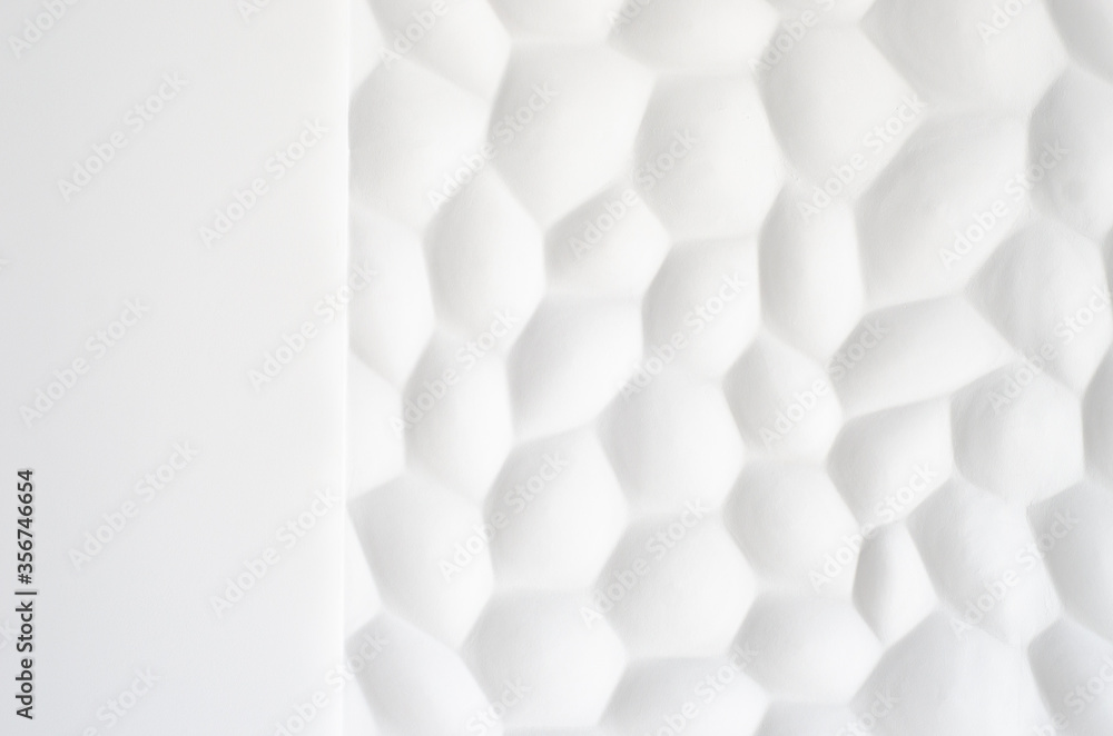 White wall with a wavy texture. Gypsum panels with geometric patterns ...