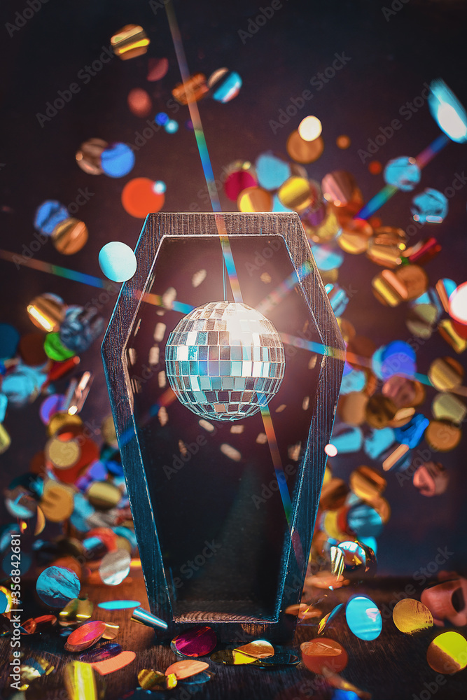Disco ball in a coffin with confetti, memento mori concept, death dance ...
