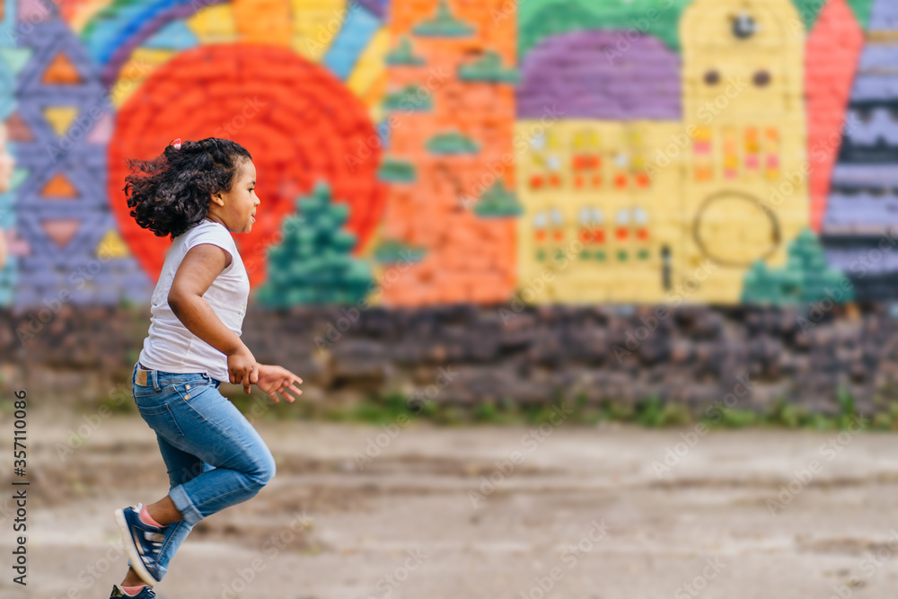 African american cute little girl having fun while run away, racing on ...