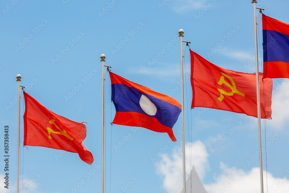 The Lao National Flag with the red flag with communist symbols of a ...