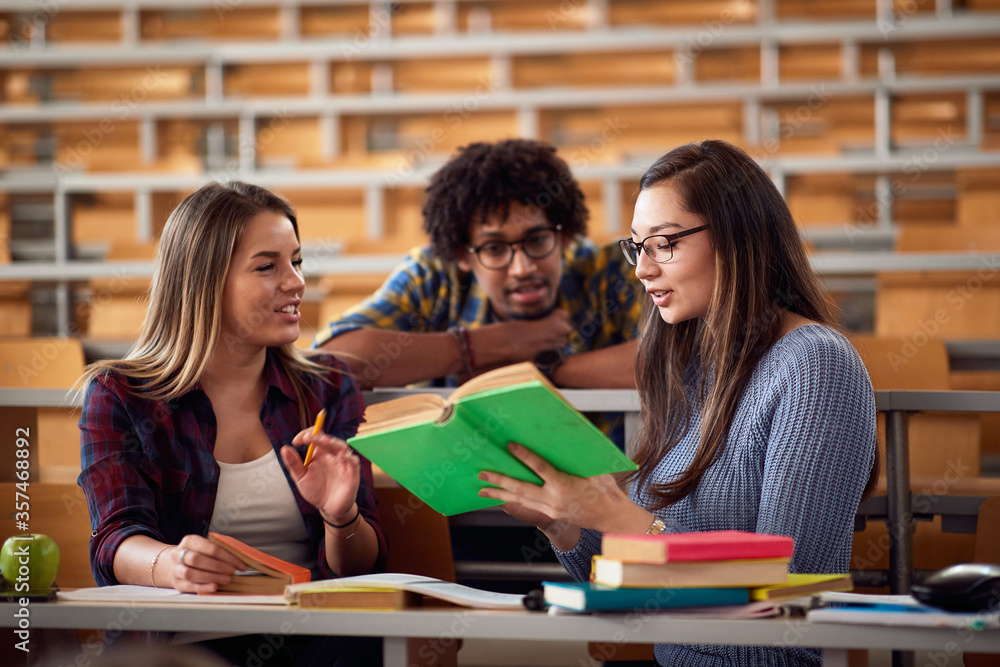 Young college students branstorming and comparing notes Stock Photo ...