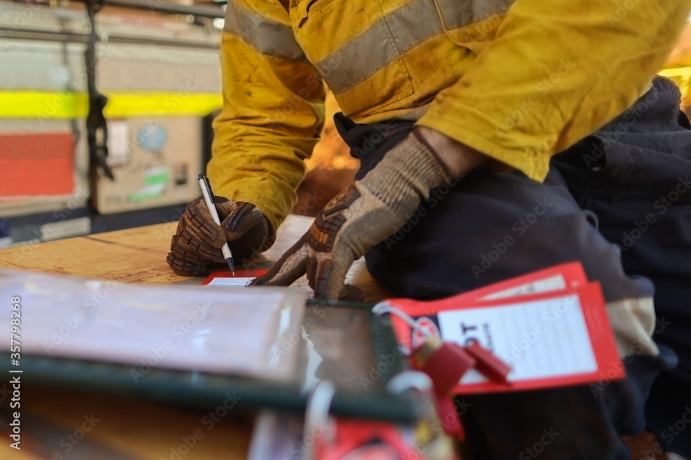 Safety practise construction worker setting and writing his name on ...