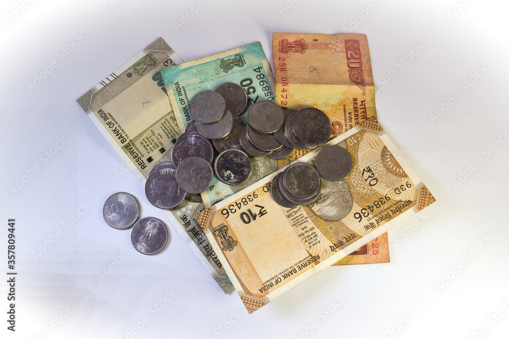 Pile of Indian Currency notes and coins on white background. Artistic ...