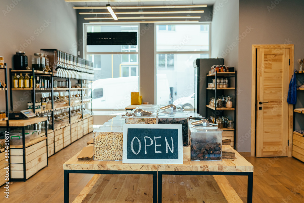 Zero waste shop interior. Wooden counters and shelves with different ...
