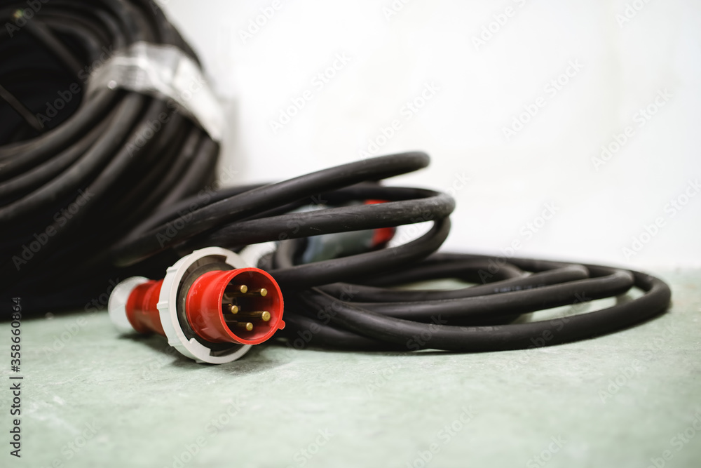 Cable with industrial 32A 5PIN plug connector lying on the ground ...