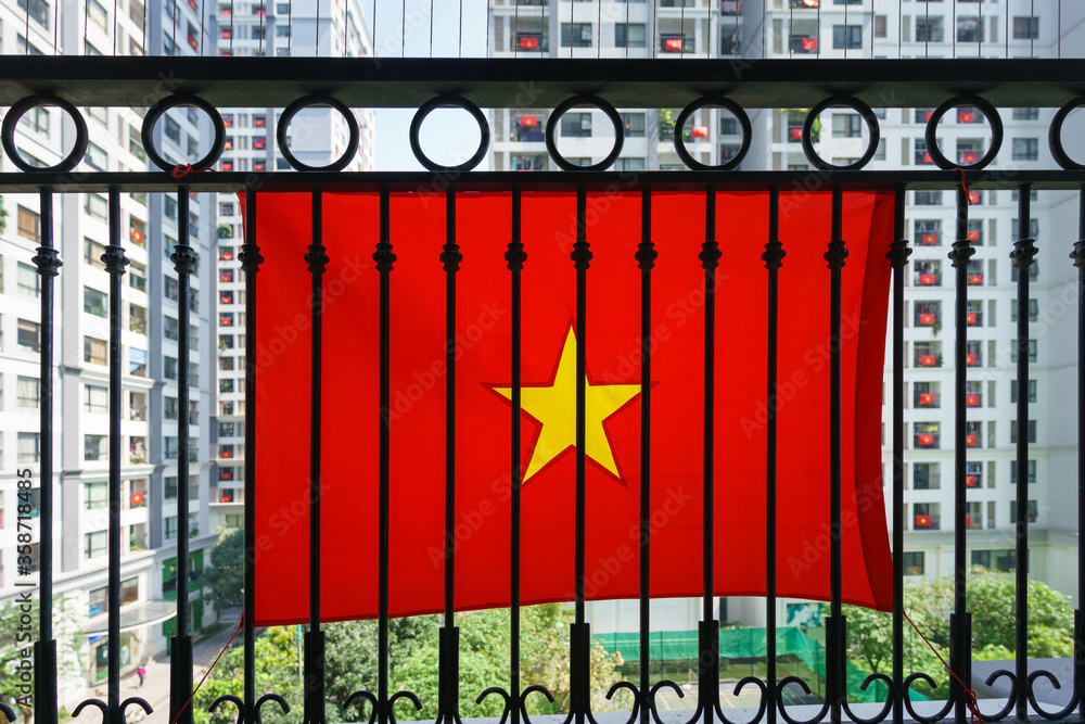 Vietnamese flag hanging on balcony of residental apartment building ...