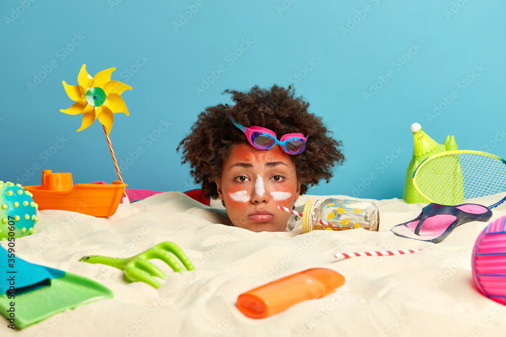 Summer holidays and vacation concept. Sad ethnic woman stuck in beach ...