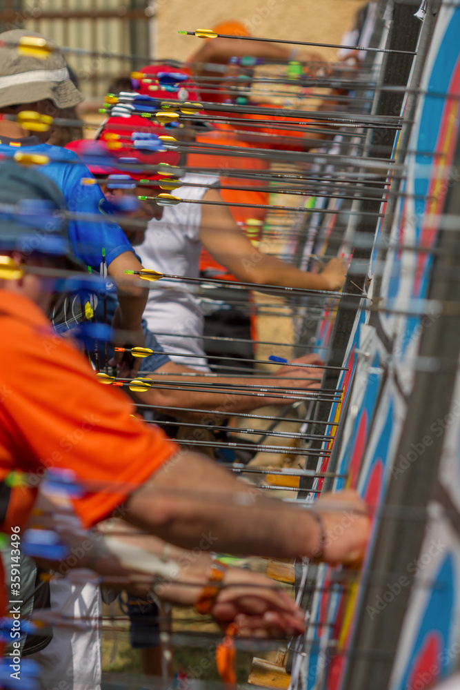 Side view of olympic archery paper target with arrows and archers ...