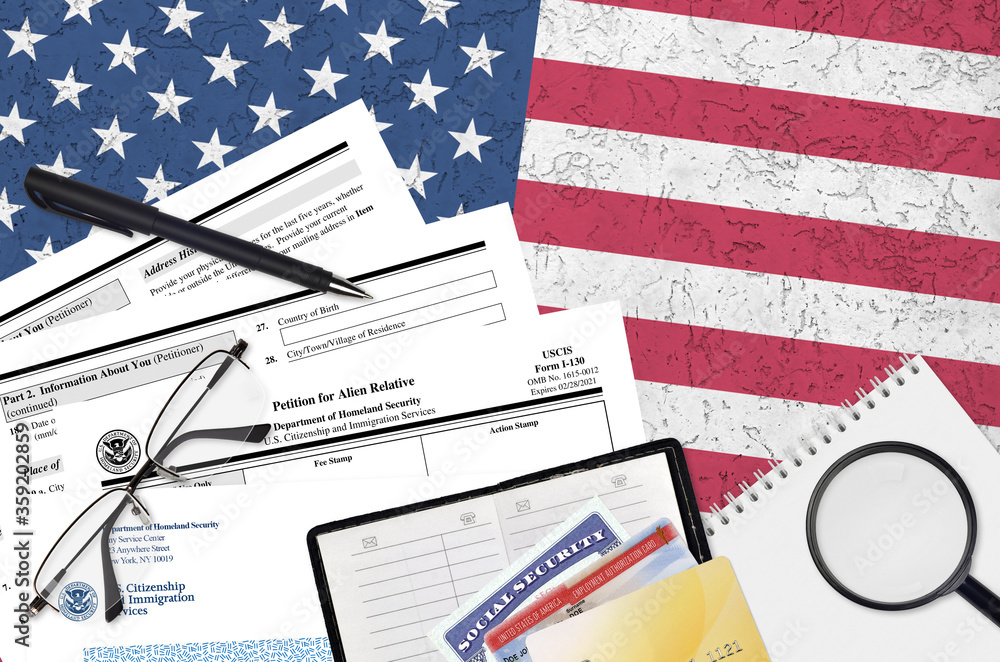USCIS form I-130 petition for alien relative lies on flat lay office ...
