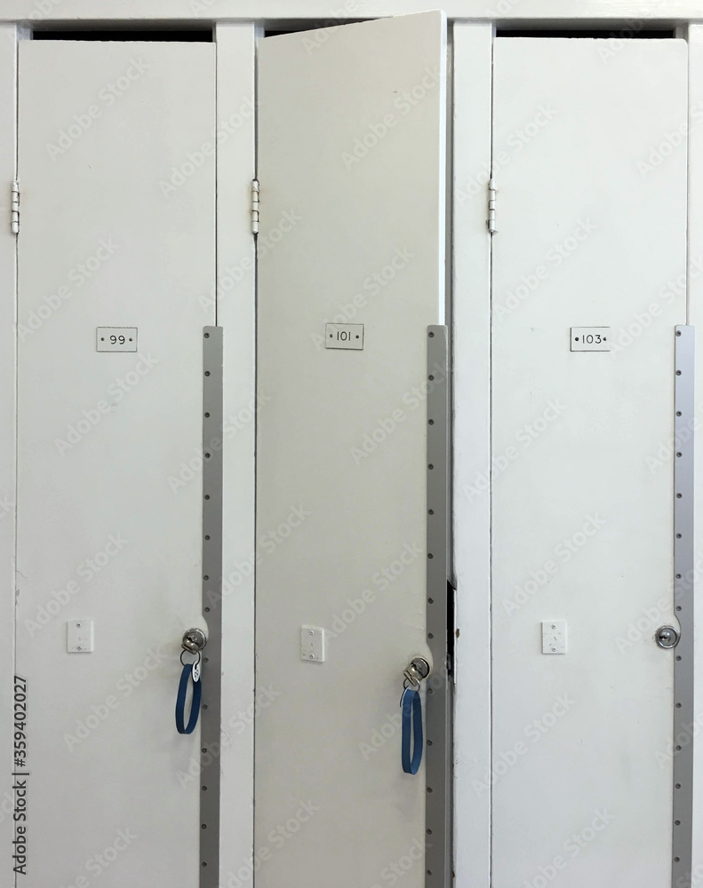 Old white lockers in a locker room. Stock Photo | Adobe Stock