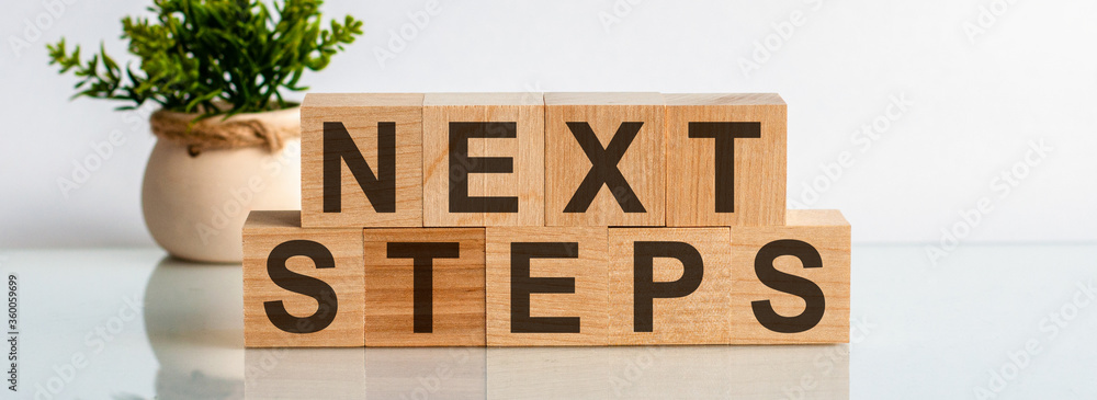 Next Steps motivation text on wooden blocks business concept white ...