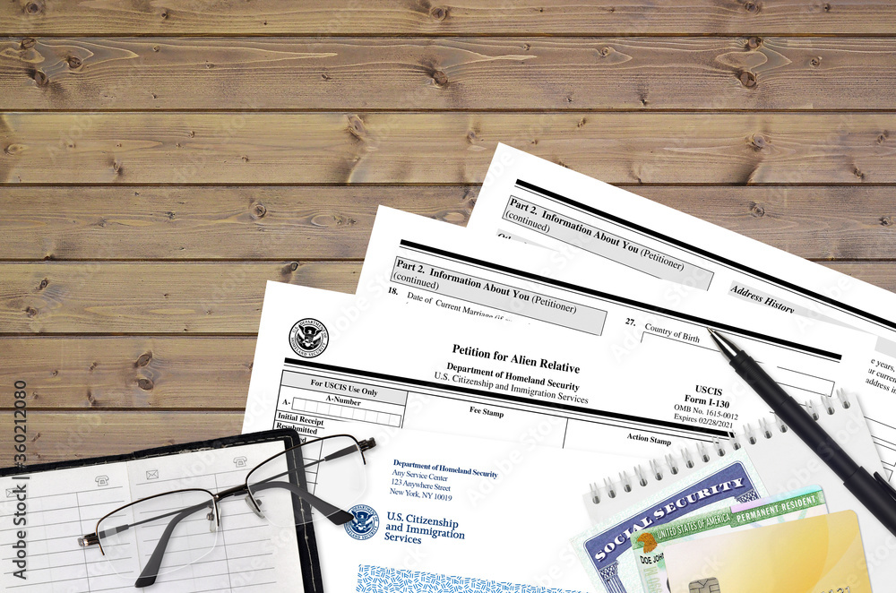 USCIS form I-130 petition for alien relative lies on flat lay office ...