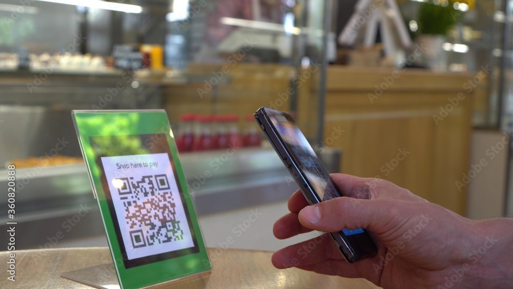Smartphone scanning the recipient’s QR code. Mobile banking. Customers ...