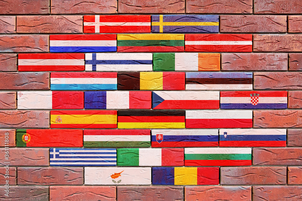 Flags of the EU countries on the brick wall. A wall of bricks with ...