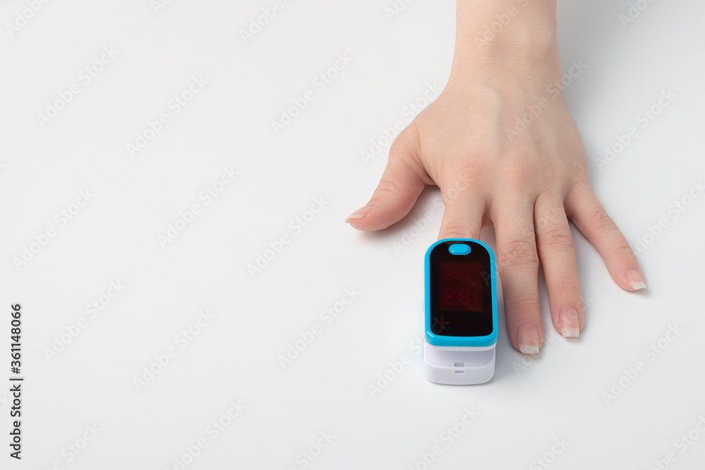 Saturation of hemoglobin of blood with oxygen. Female finger in a pulse ...