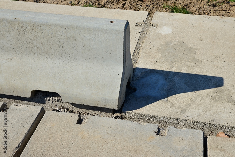 Concrete block separating the panel road from the pavement. road made ...
