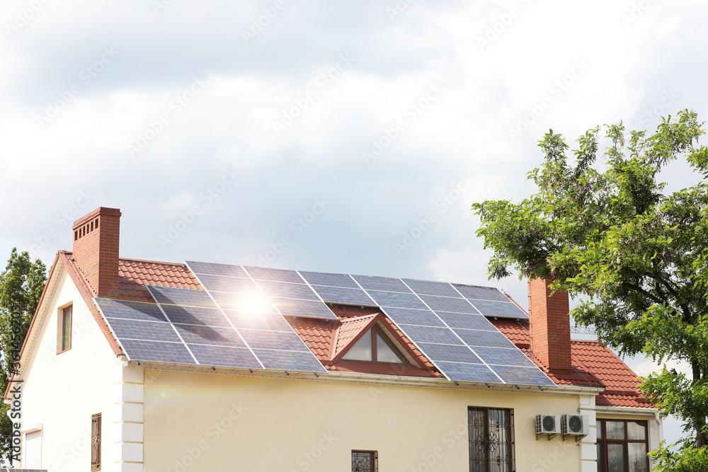 Building with installed solar panels on roof. Alternative energy source ...