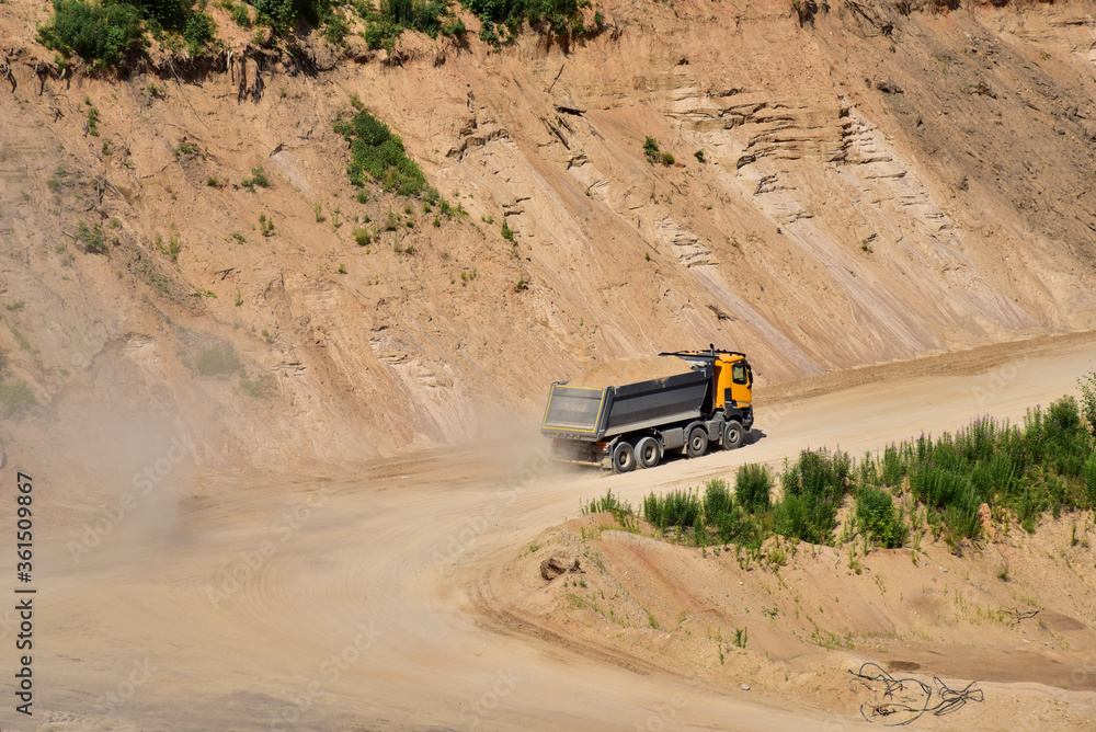 Dump truck transports sand in open pit mine. In the production of ...
