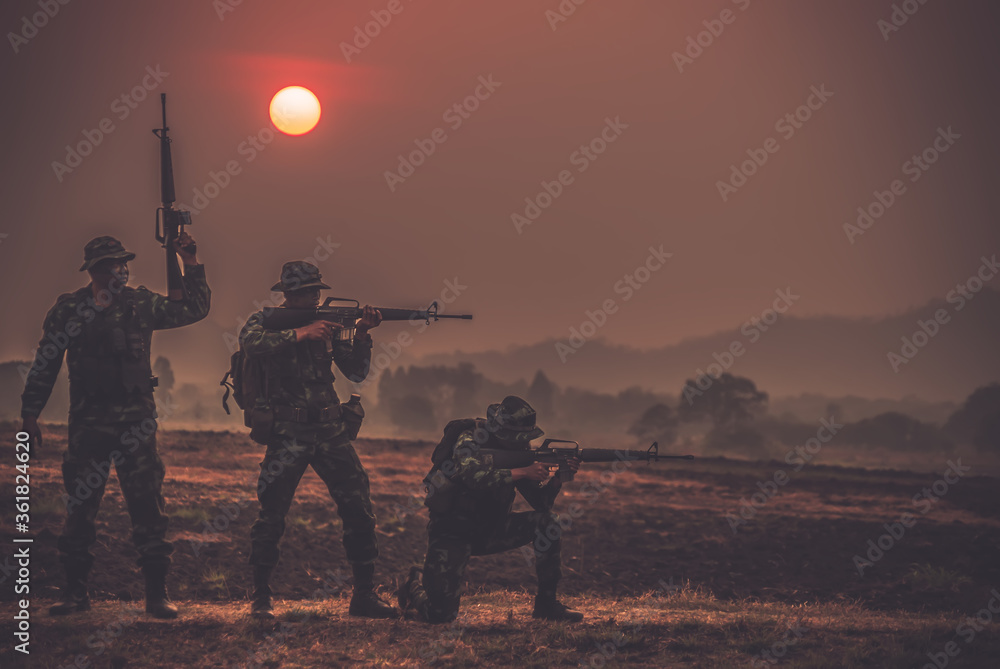 Team special forces. soldier assault rifle with silencer.Silhouette ...