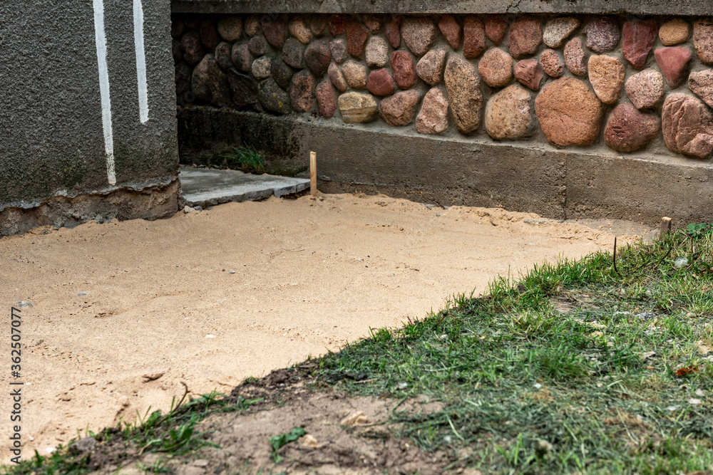 Leveling the foundation with sand for laying paving slabs. Stock Photo ...