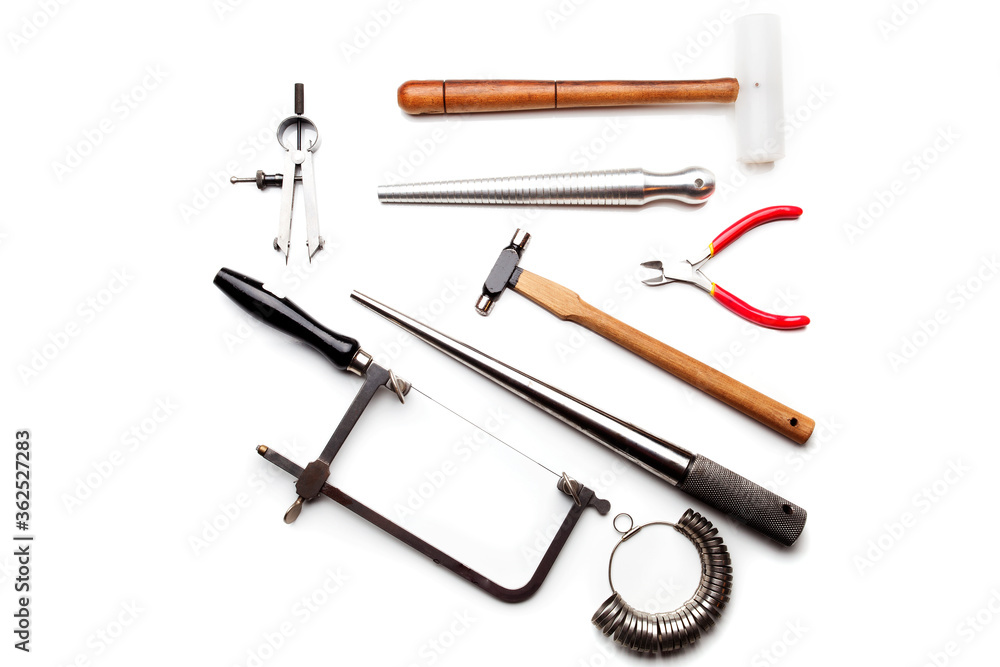 Different goldsmiths tools on the jewelry workplace. Desktop for craft ...