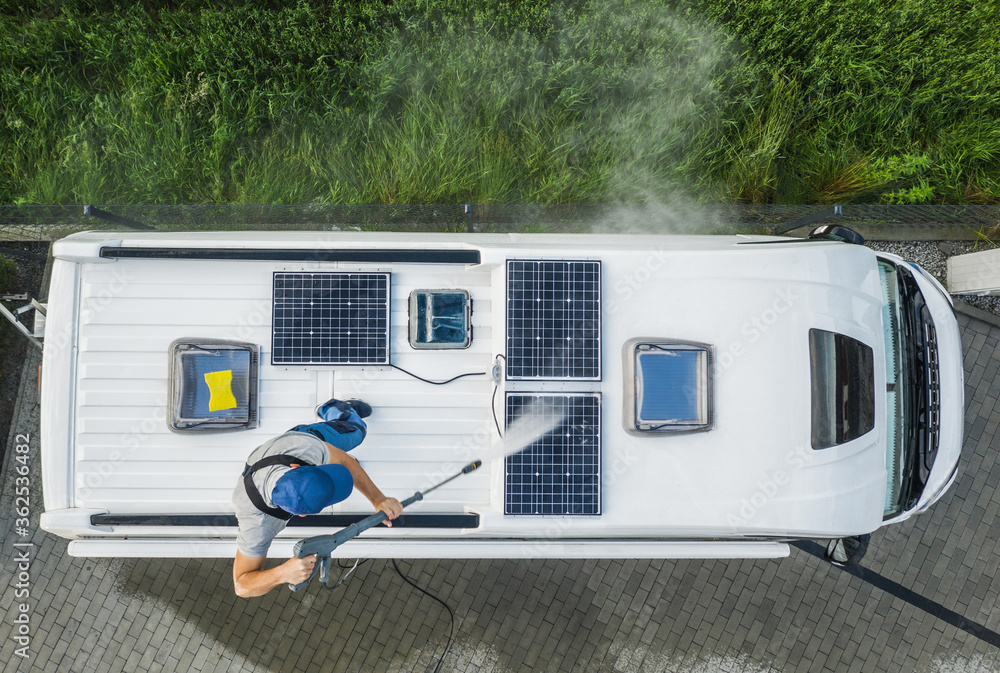 Men Pressure Washing RV Camper Van Roof Equipped with Solar Panels 素材庫 ...