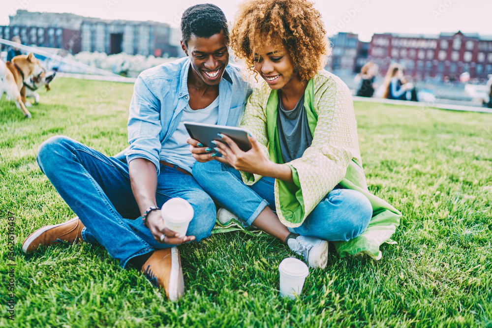 Happy dark skinned hipsters uploading to social networks account common ...